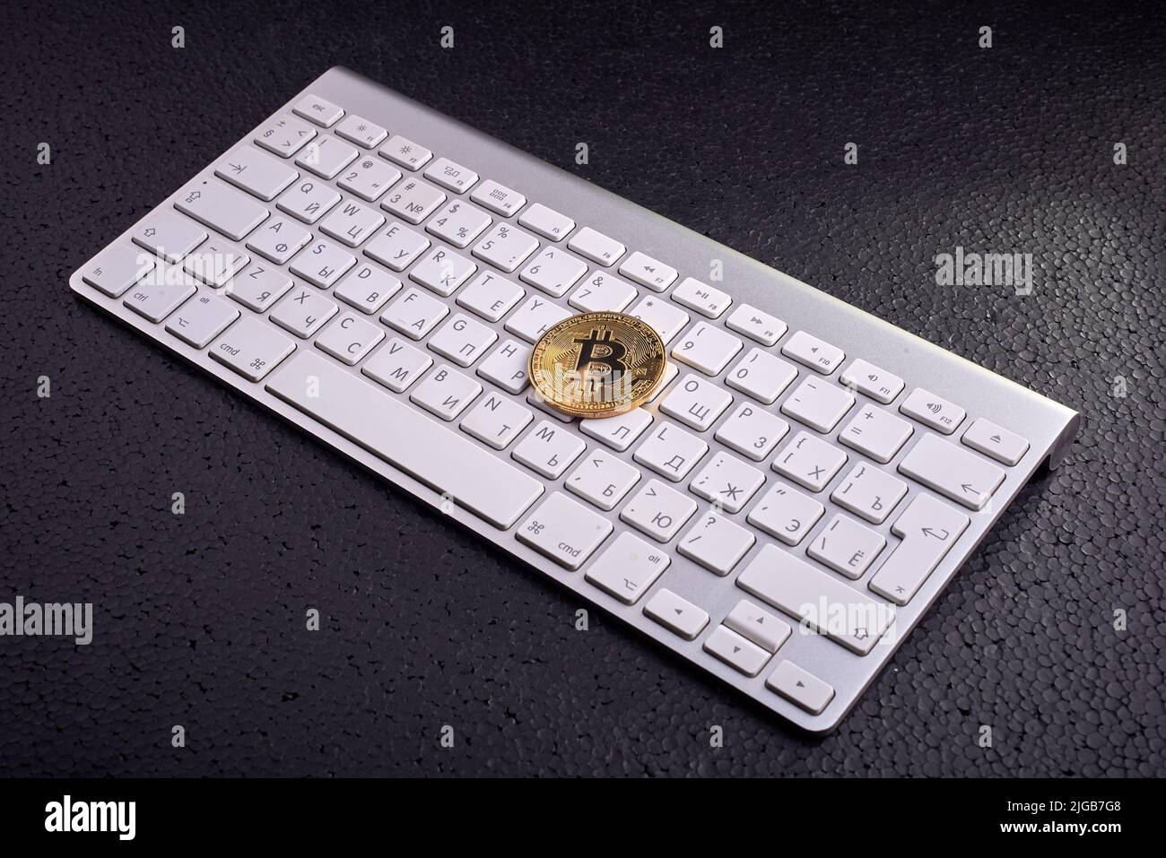 golden coin bitcoin on white keyboard Stock Photo - Alamy