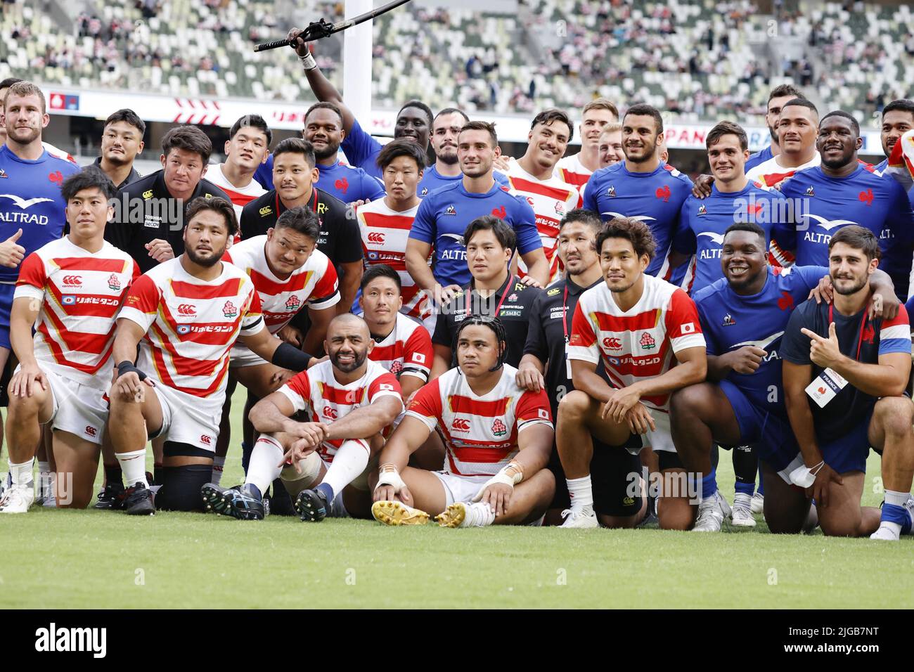 Japan's national rugby team members (front) and France's members pose ...