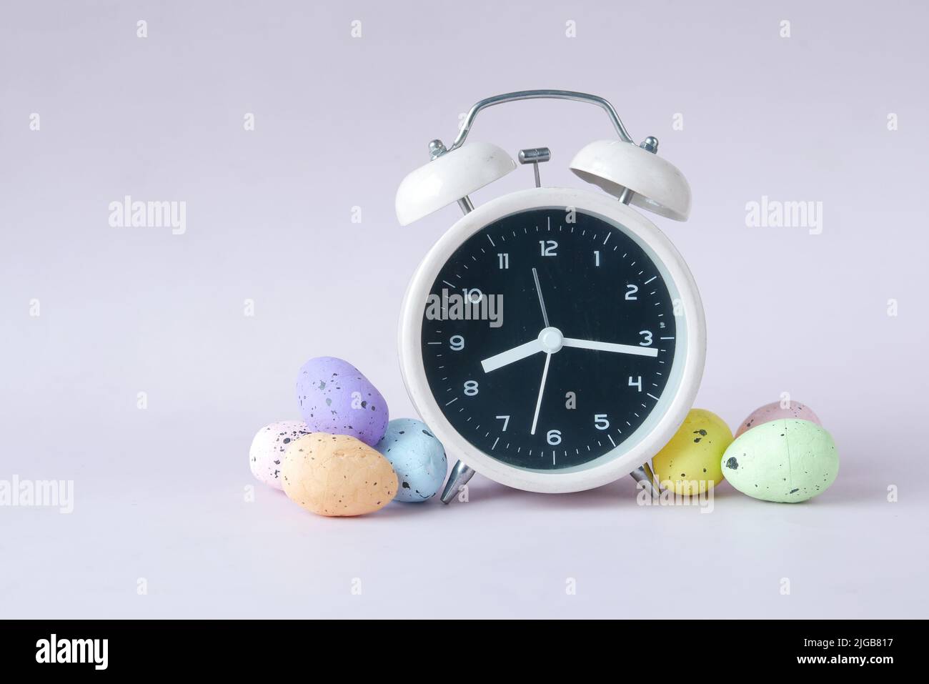 easter concept with egg and a clock on table Stock Photo - Alamy