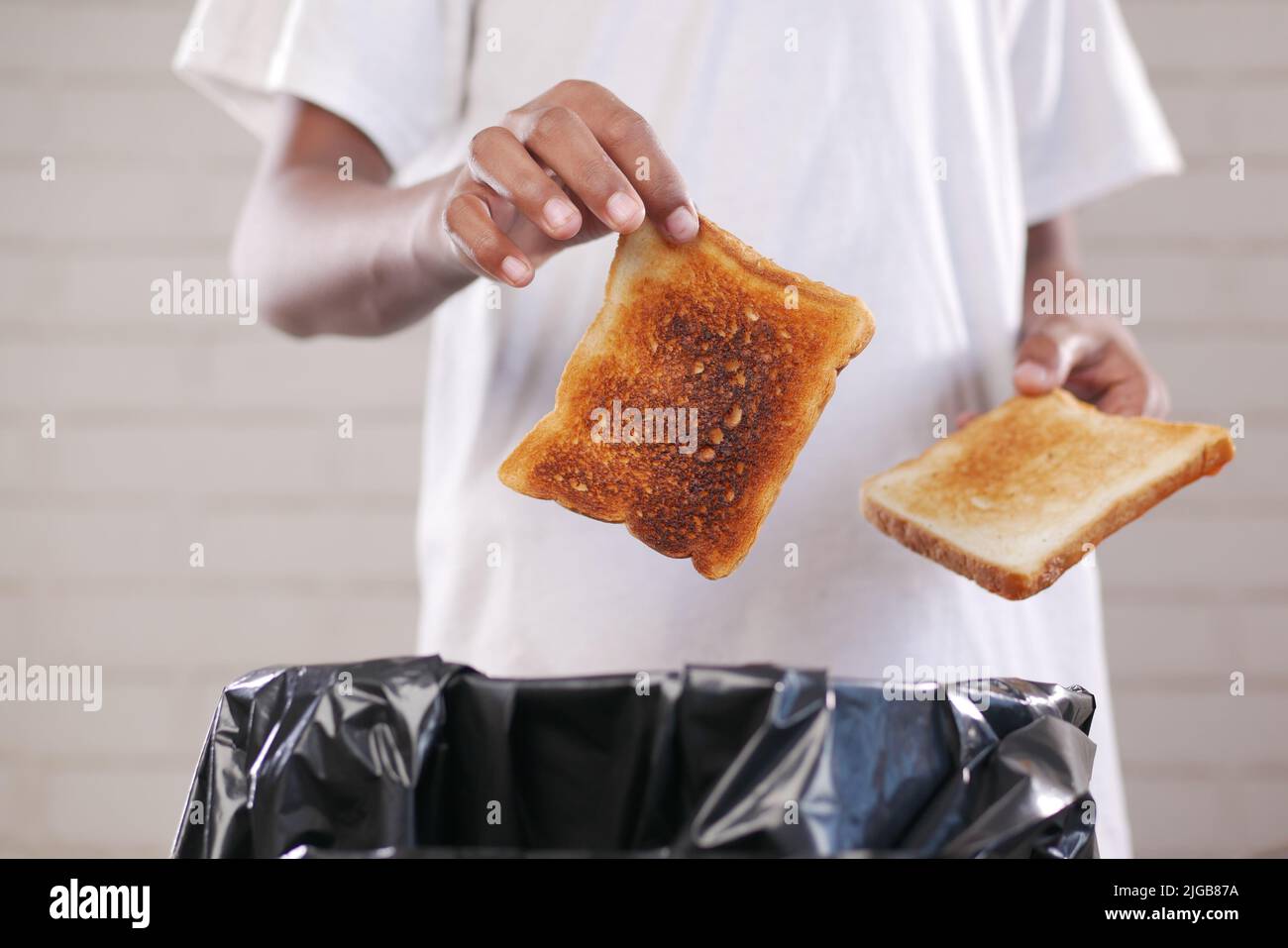 men throwing a bread in a garbage bin Stock Photo - Alamy