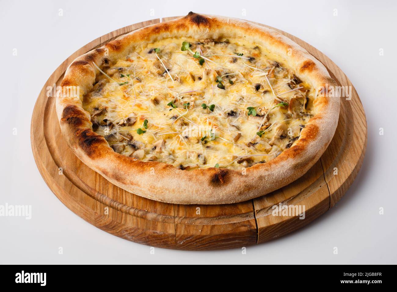 Top view of hot pizza on a wooden stand. Fungi pizza, tender creamy ...