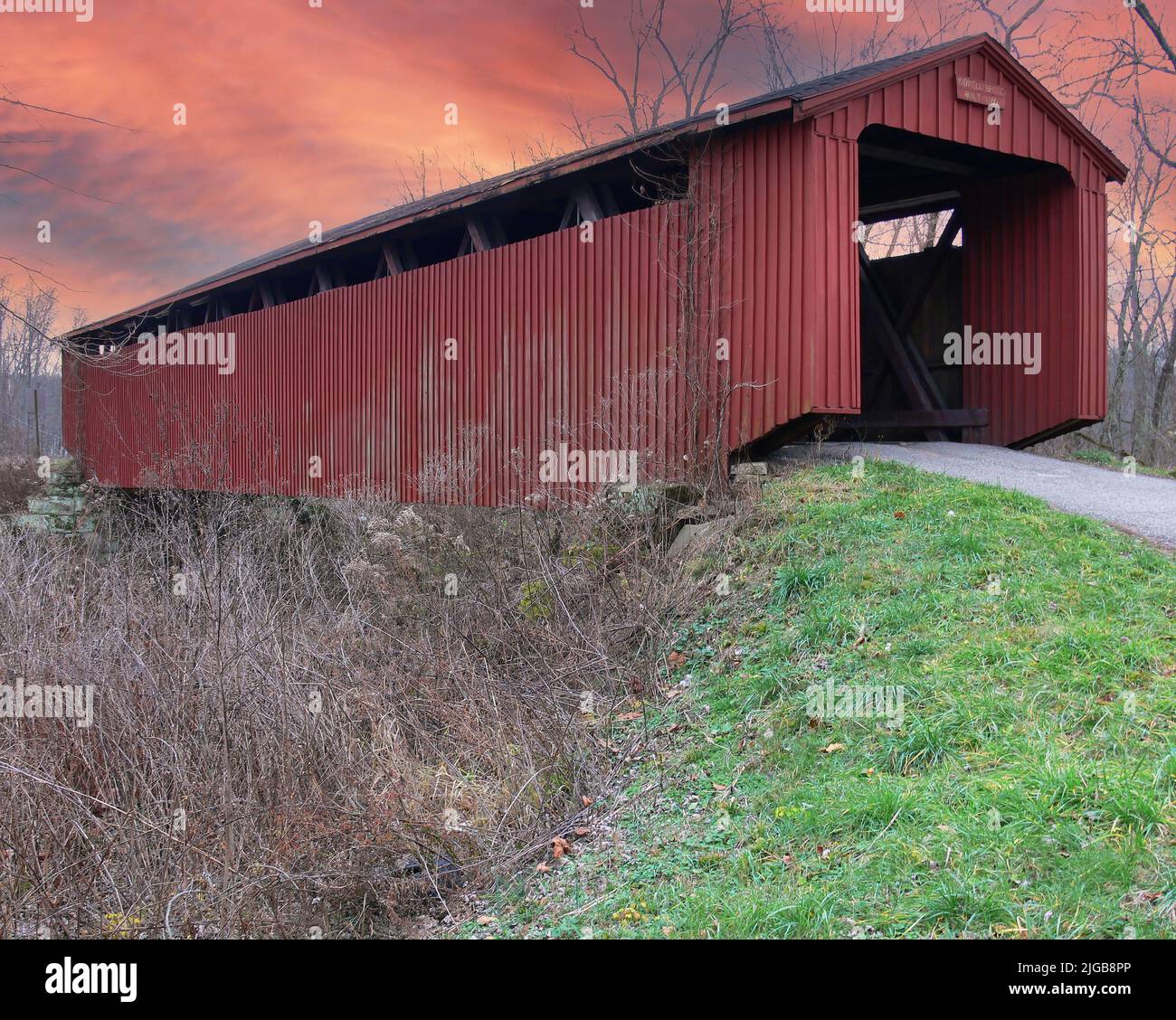 A covered bridge along the way during sunset Stock Photo - Alamy