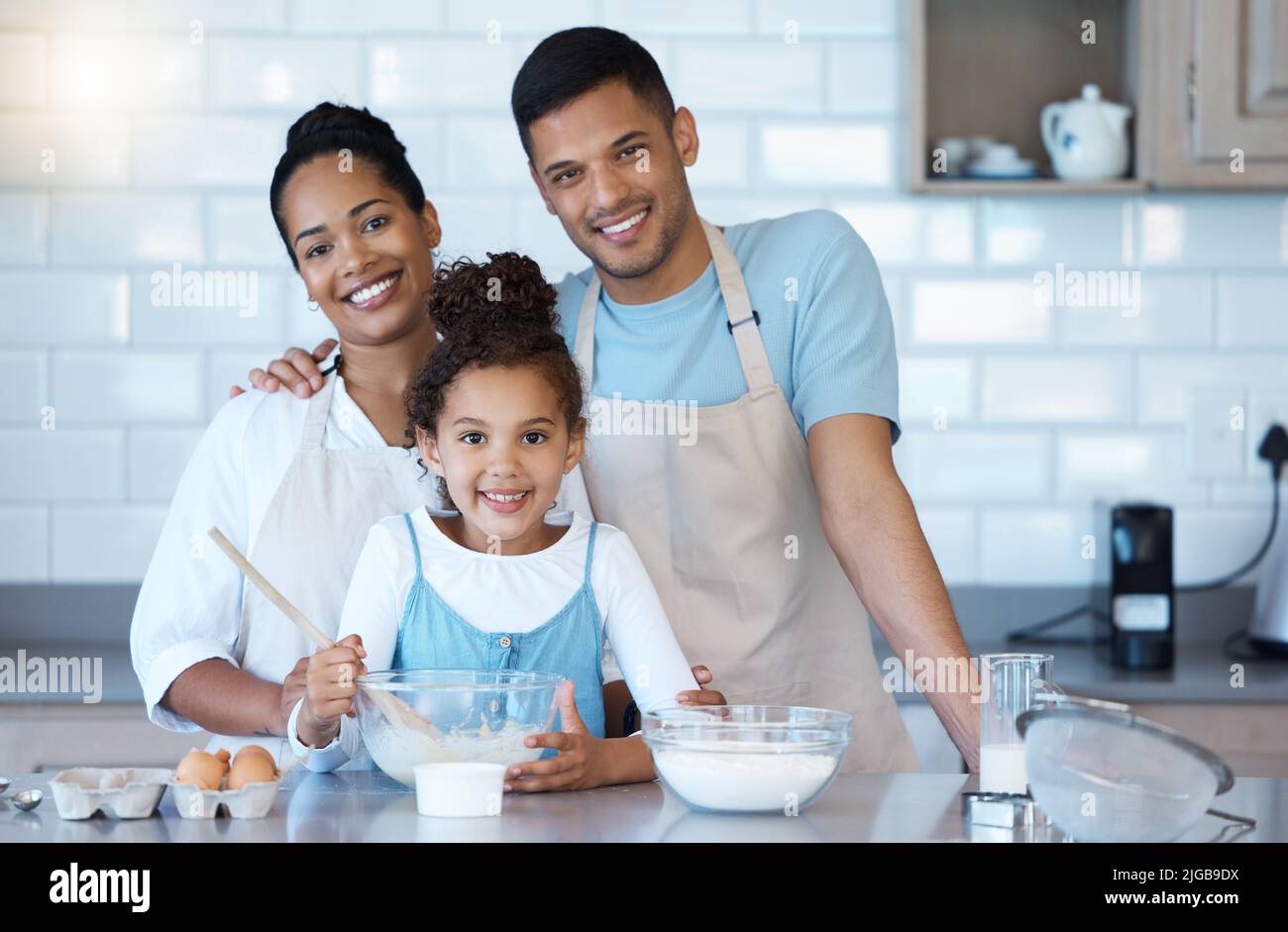 Portrait of a loving hispanic family baking together at home. Adorable ...