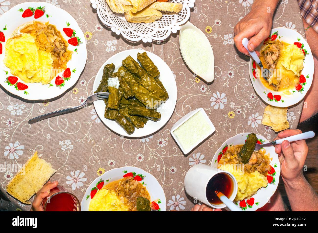 Dinner table with dolma, potatoes, cabbage and sauce. Eating at home ...