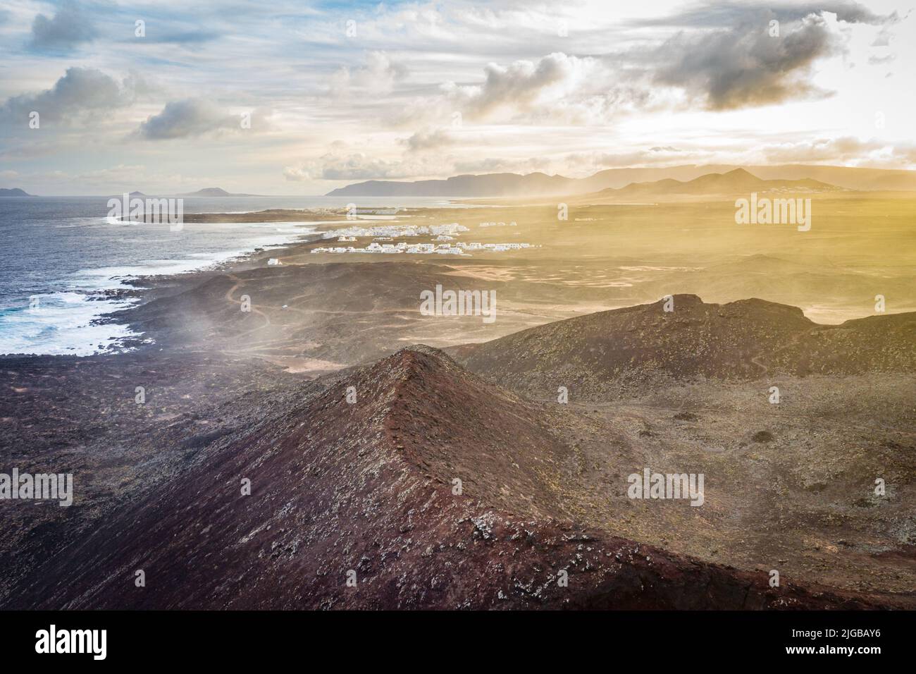 aerial view on volcano and mountains on coast with ocean waves on ...