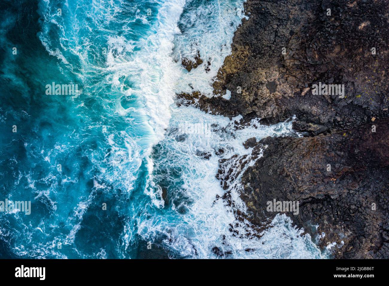 aerial view of ocean waves breaking on rocky coast Stock Photo - Alamy