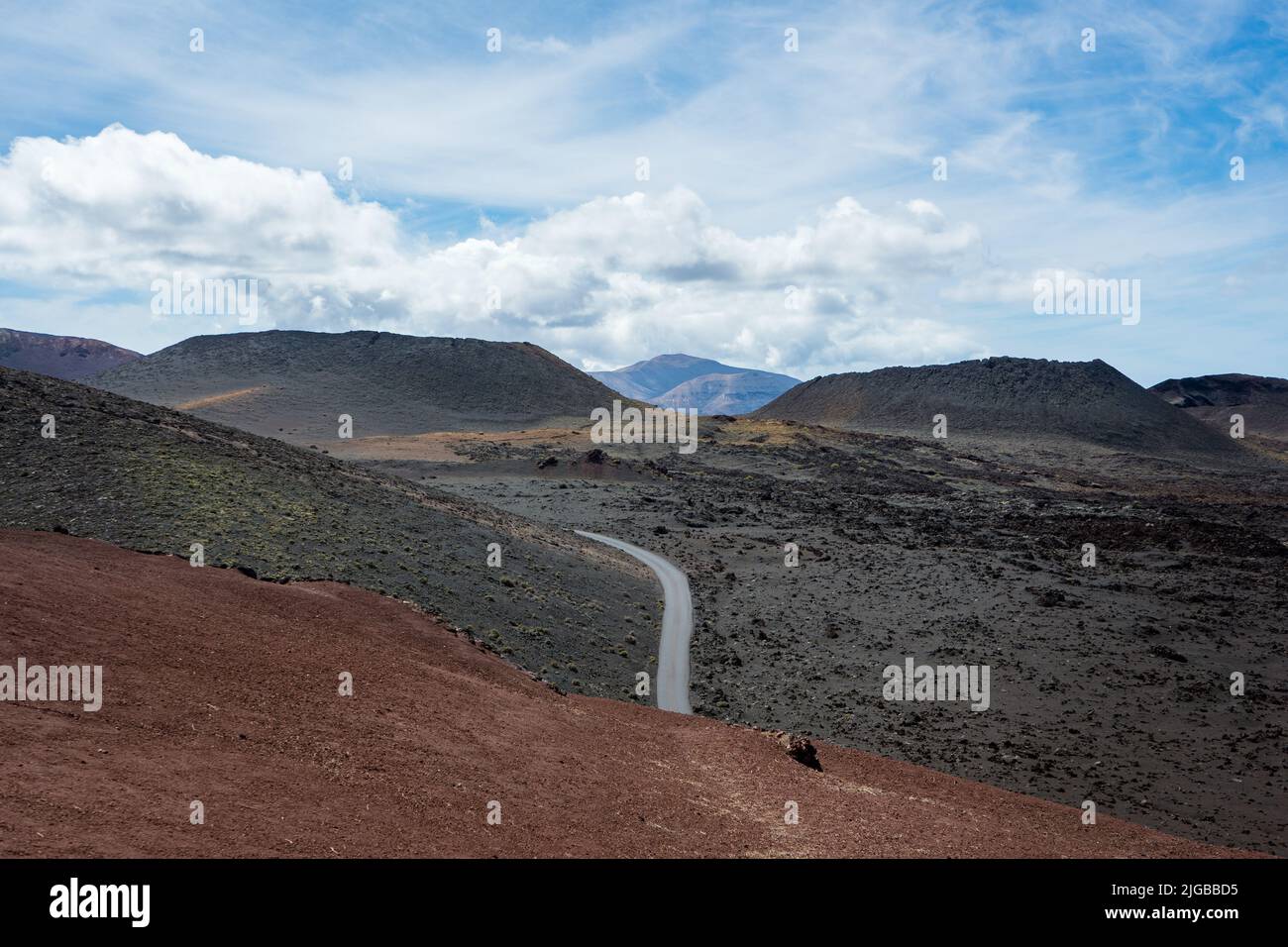 road leading through volcanic landscape in national park timanfaya ...