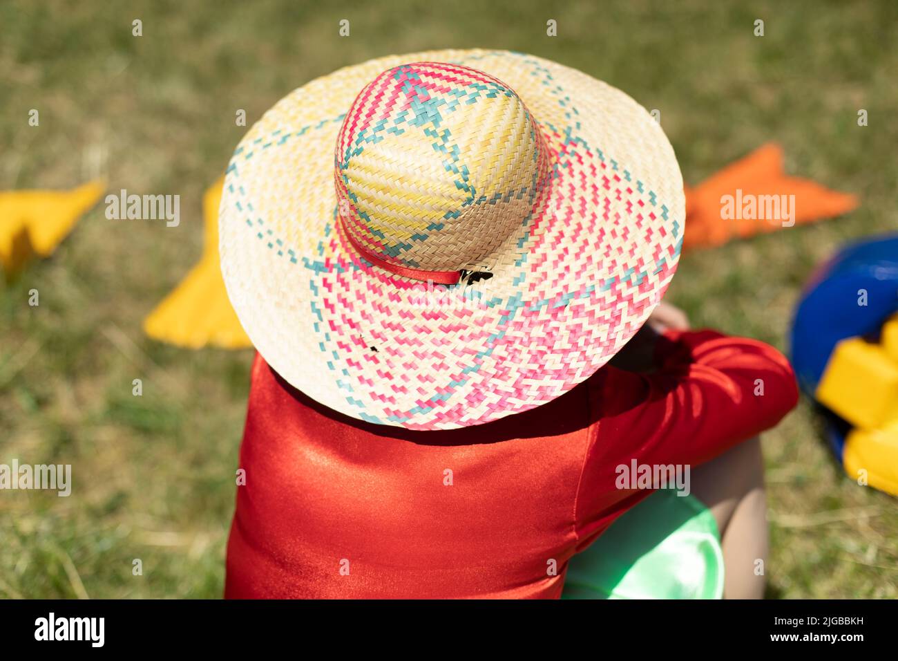 Straw hat on guy. Cheerful clothes. Red jacket in summer. Animator at ...