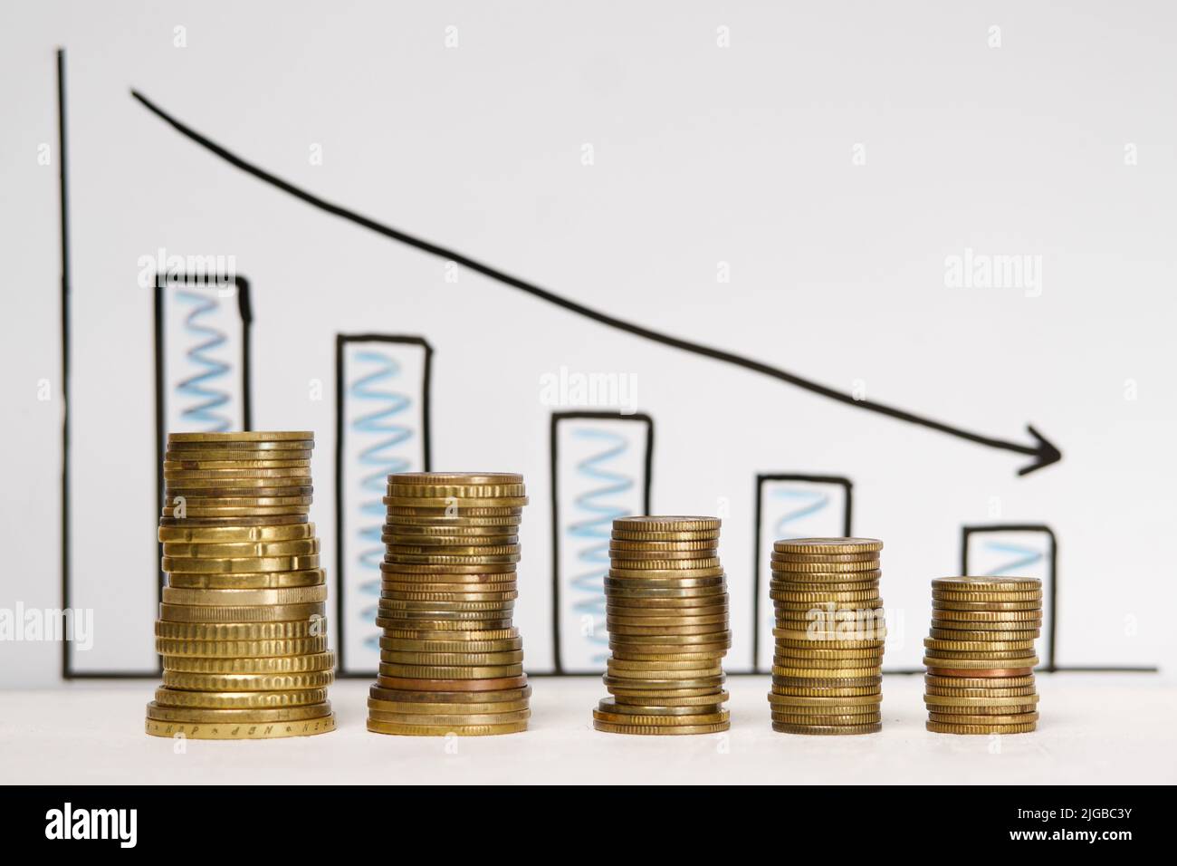 Coins stacks with economic recession graph on the background. Black ...