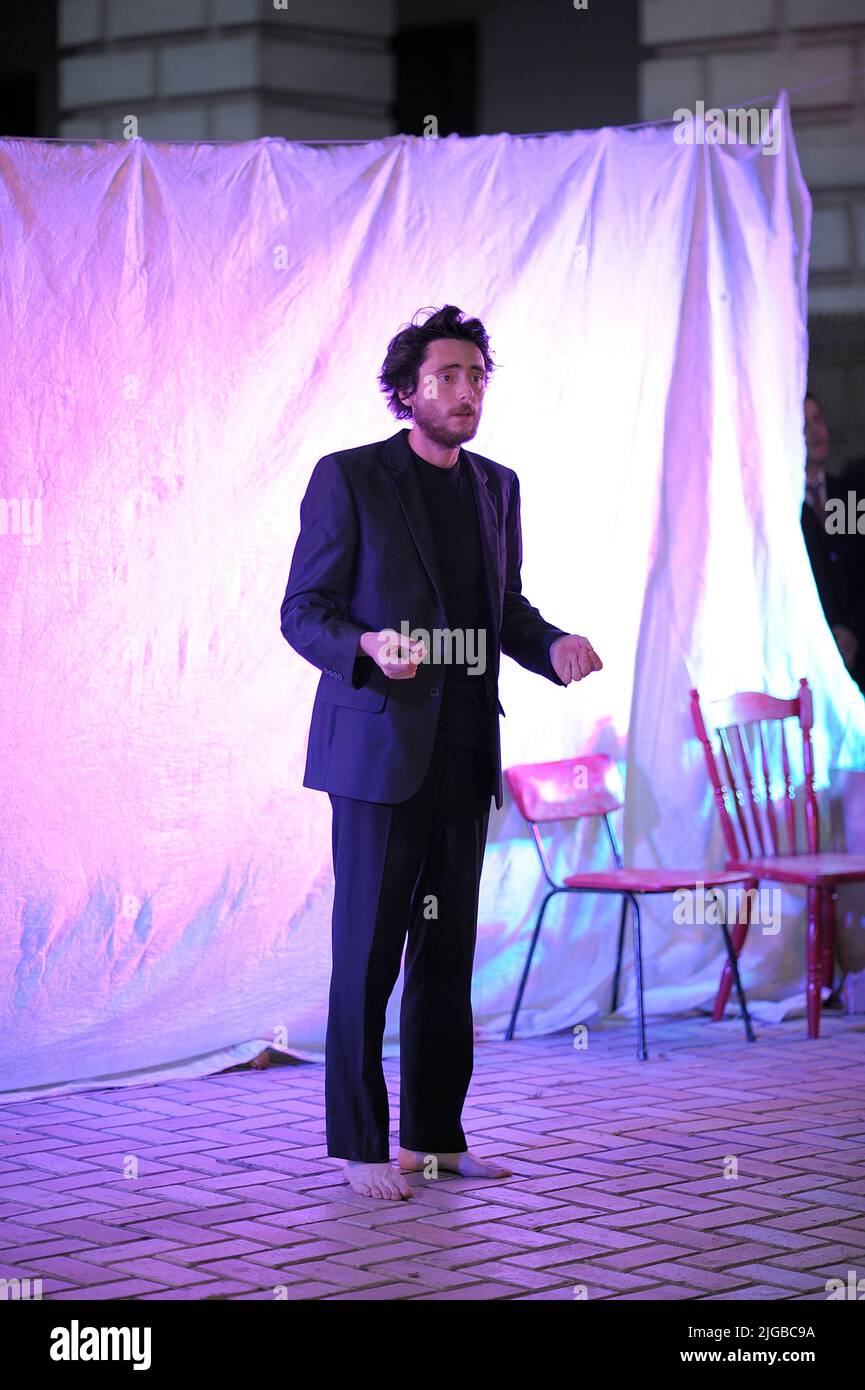 Young man actor from a street theatre performing on stage, lights are ...