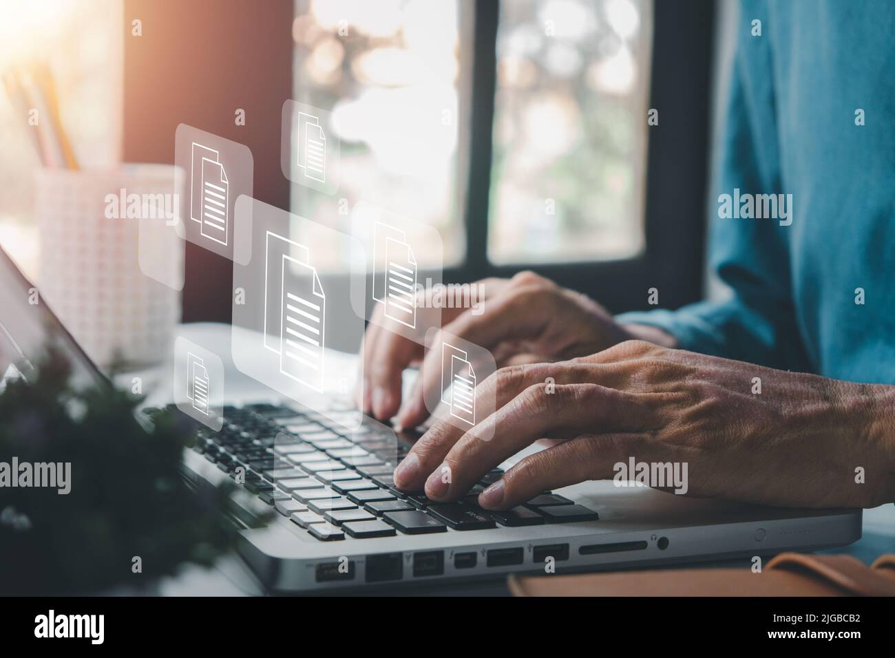 Businessman hand using laptop computer with document management icon ...