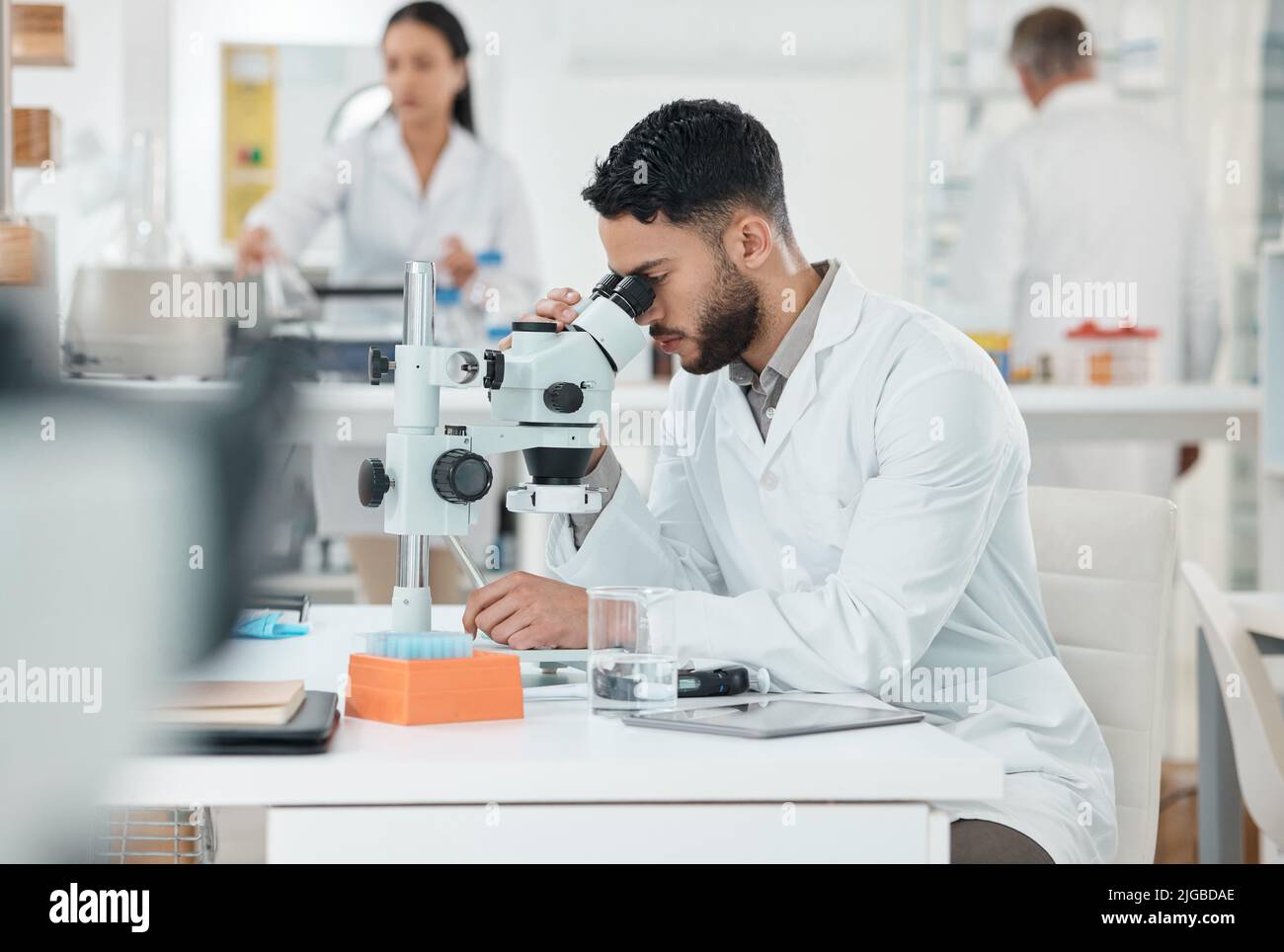 Take careful note of what you observe. a young scientist using a ...