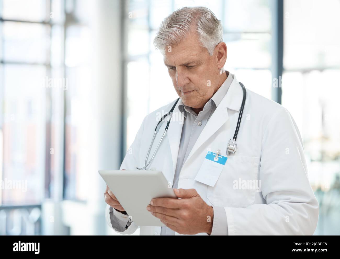 Only a doctor can teach how to love life. a doctor using a tablet in a ...