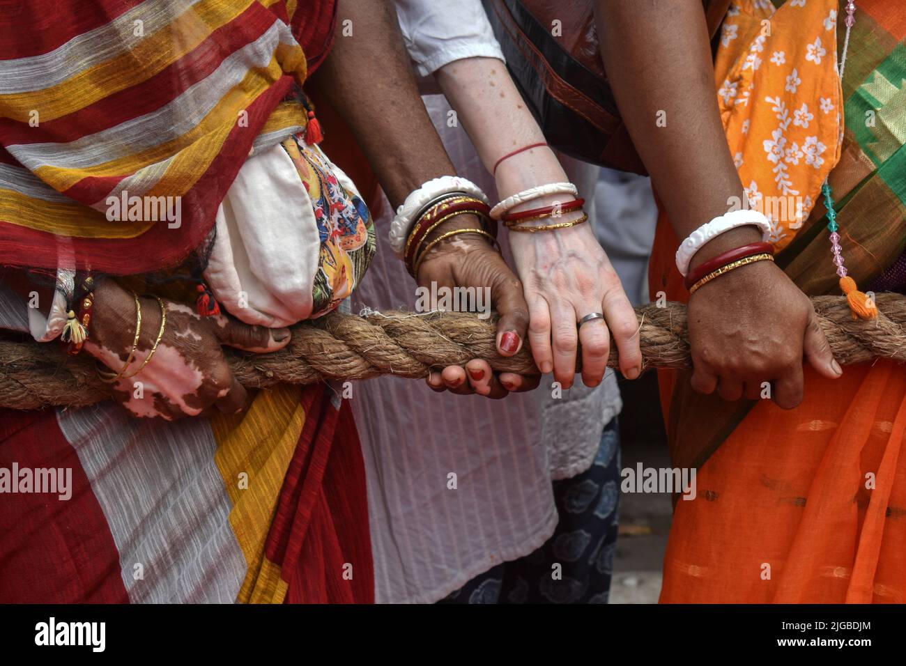 Kolkata, India. 09th July, 2022. Hindu devotees hold a rope as they ...