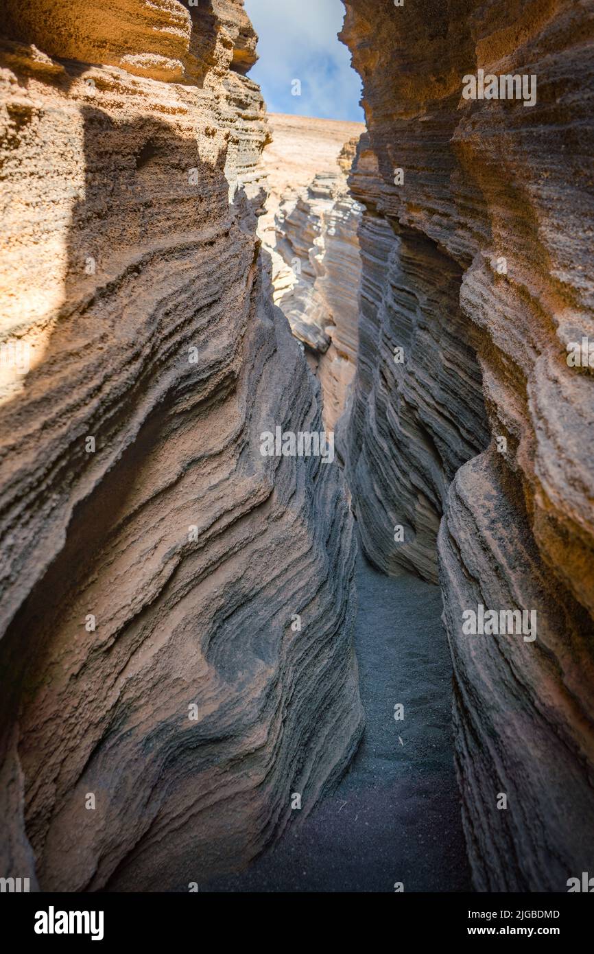walking through narrow canyon in volcano on lanzarote Stock Photo - Alamy