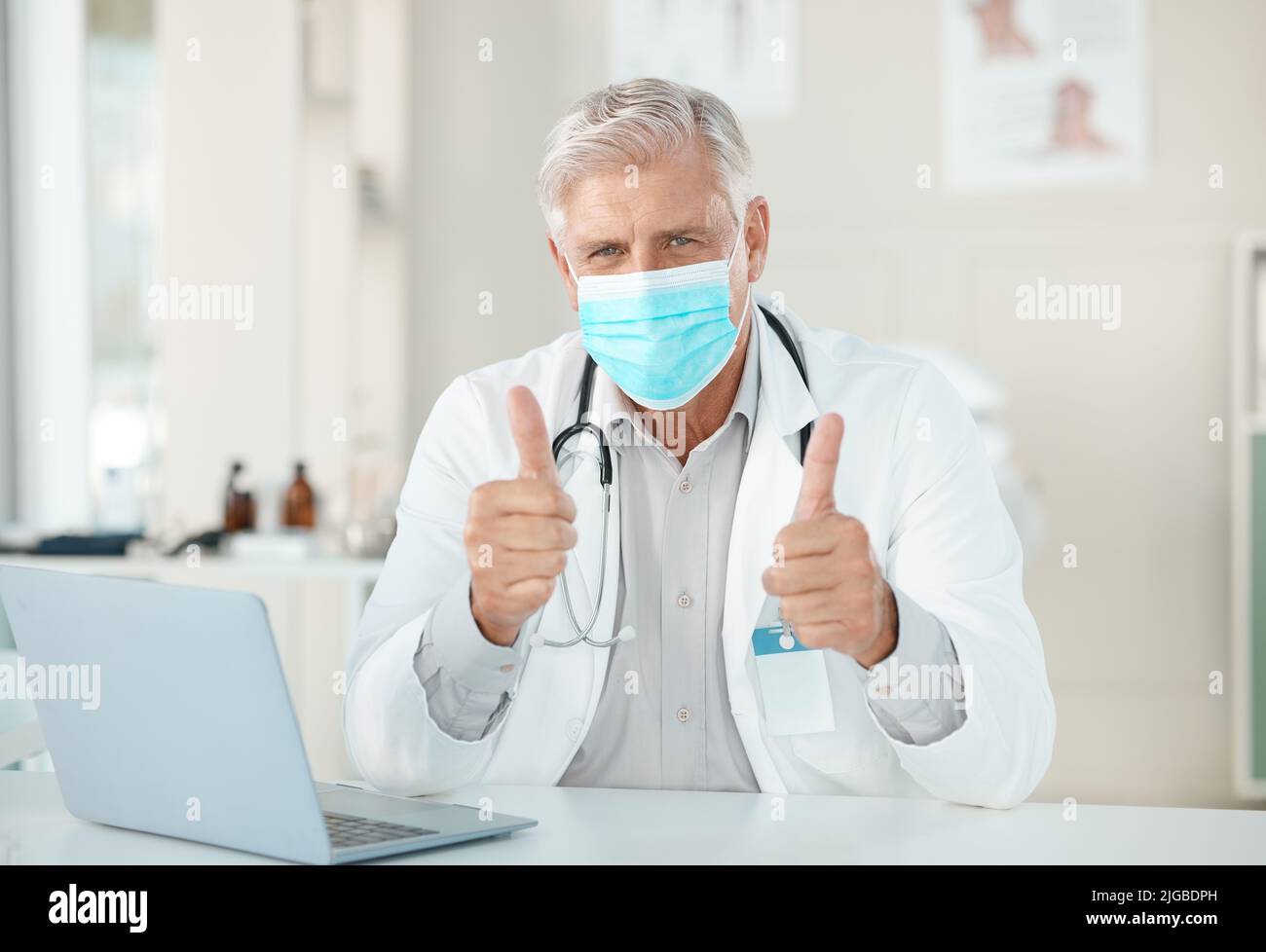 My clinic is Covid safe. a senior doctor sitting alone in his clinic ...