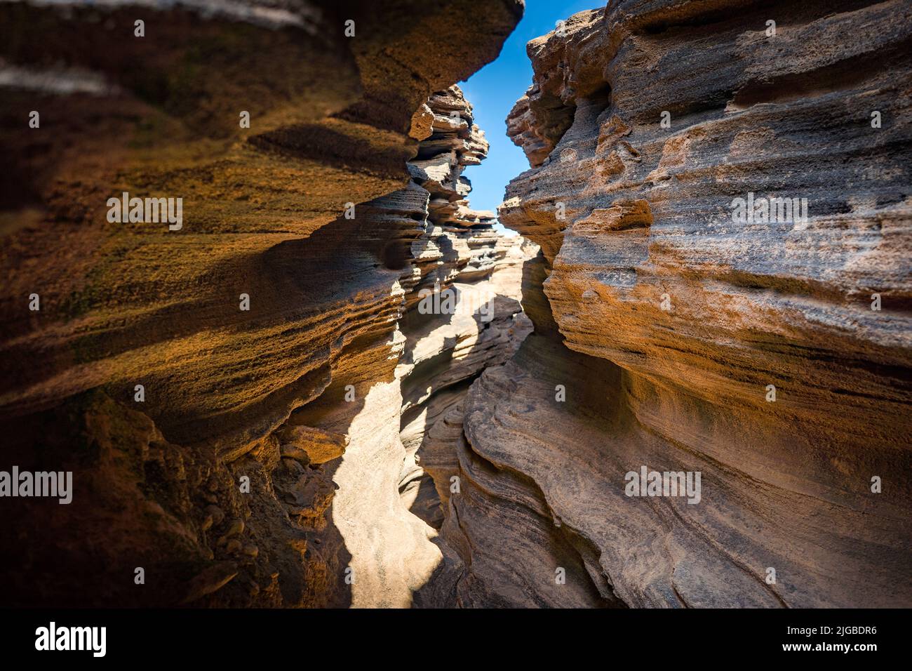 walking through narrow canyon in volcano on lanzarote Stock Photo - Alamy