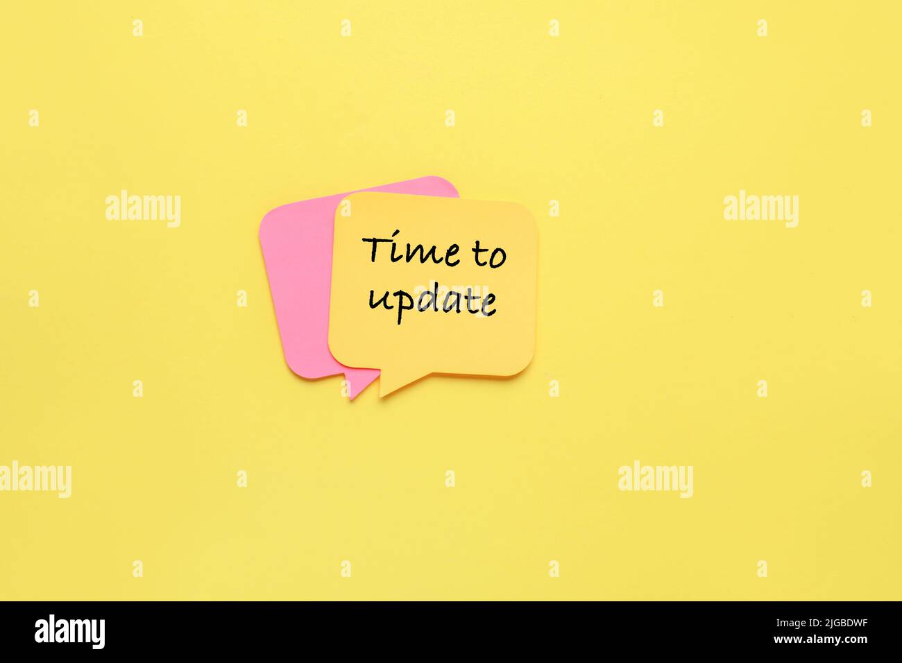 Sticky notes on yellow background. Time to update Stock Photo - Alamy
