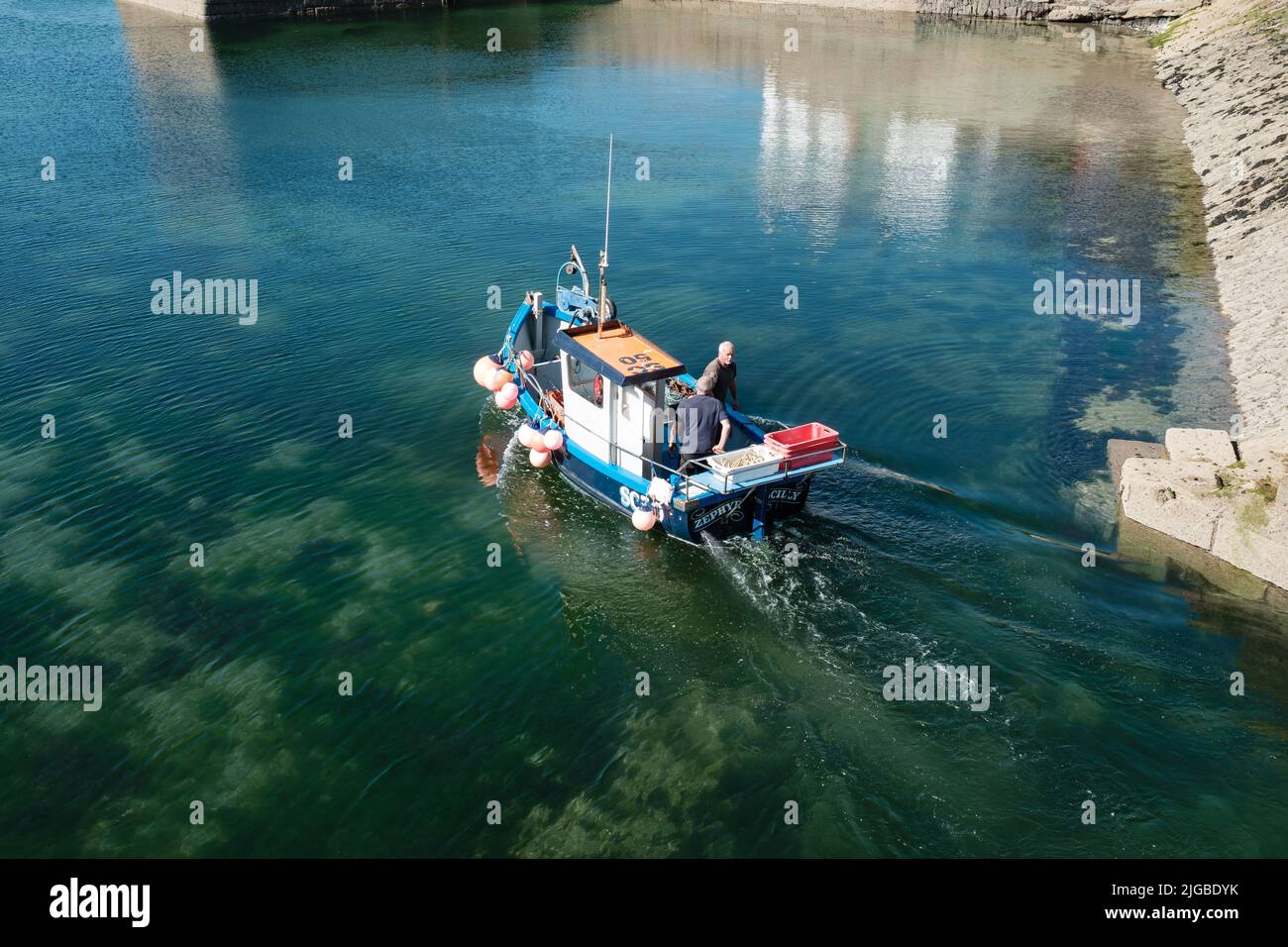 Boats leaving Porthleven Harbour, Cornwall Stock Photo - Alamy
