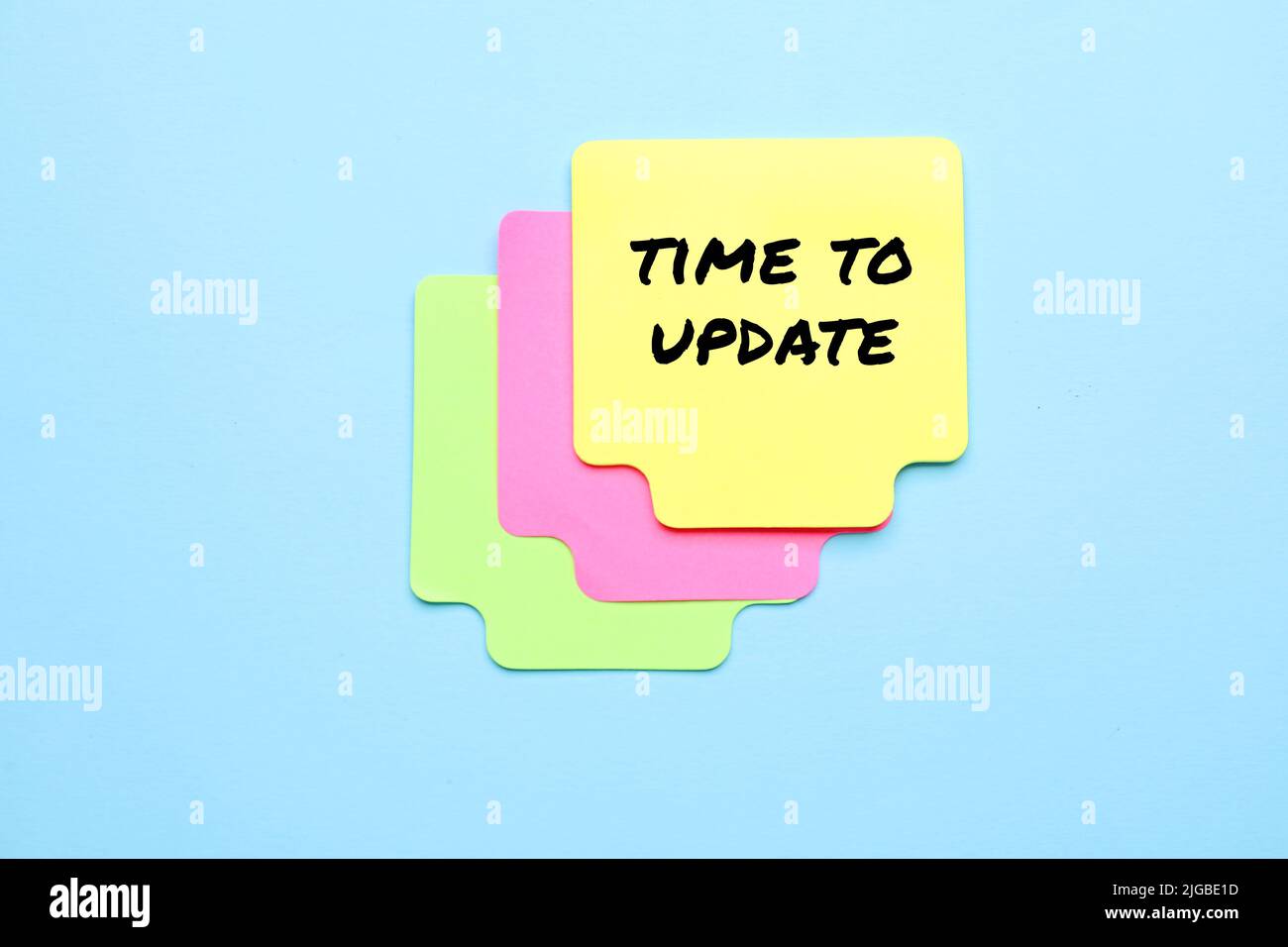 Sticky notes on blue background. Time to update Stock Photo - Alamy