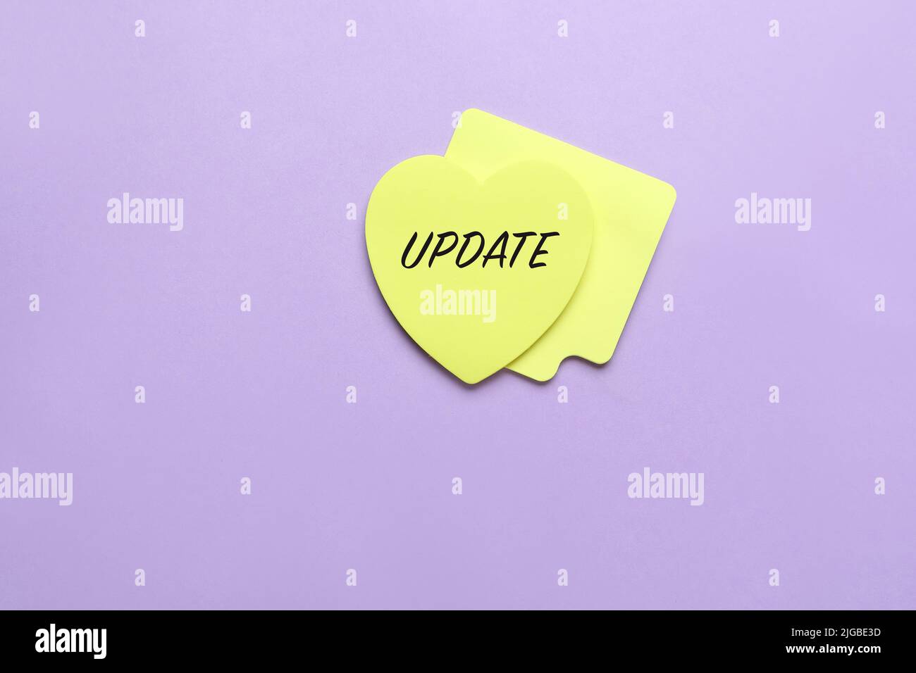 Sticky notes on lilac background. Update concept Stock Photo - Alamy