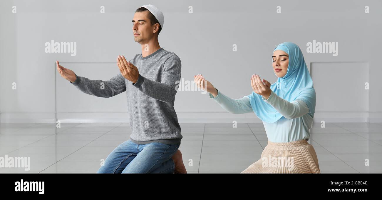 Muslim couple praying at home Stock Photo - Alamy