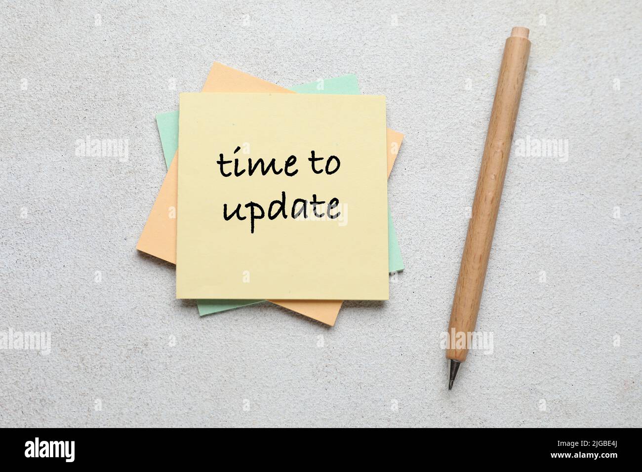 Sticky notes and pen on light background. Time to update Stock Photo ...