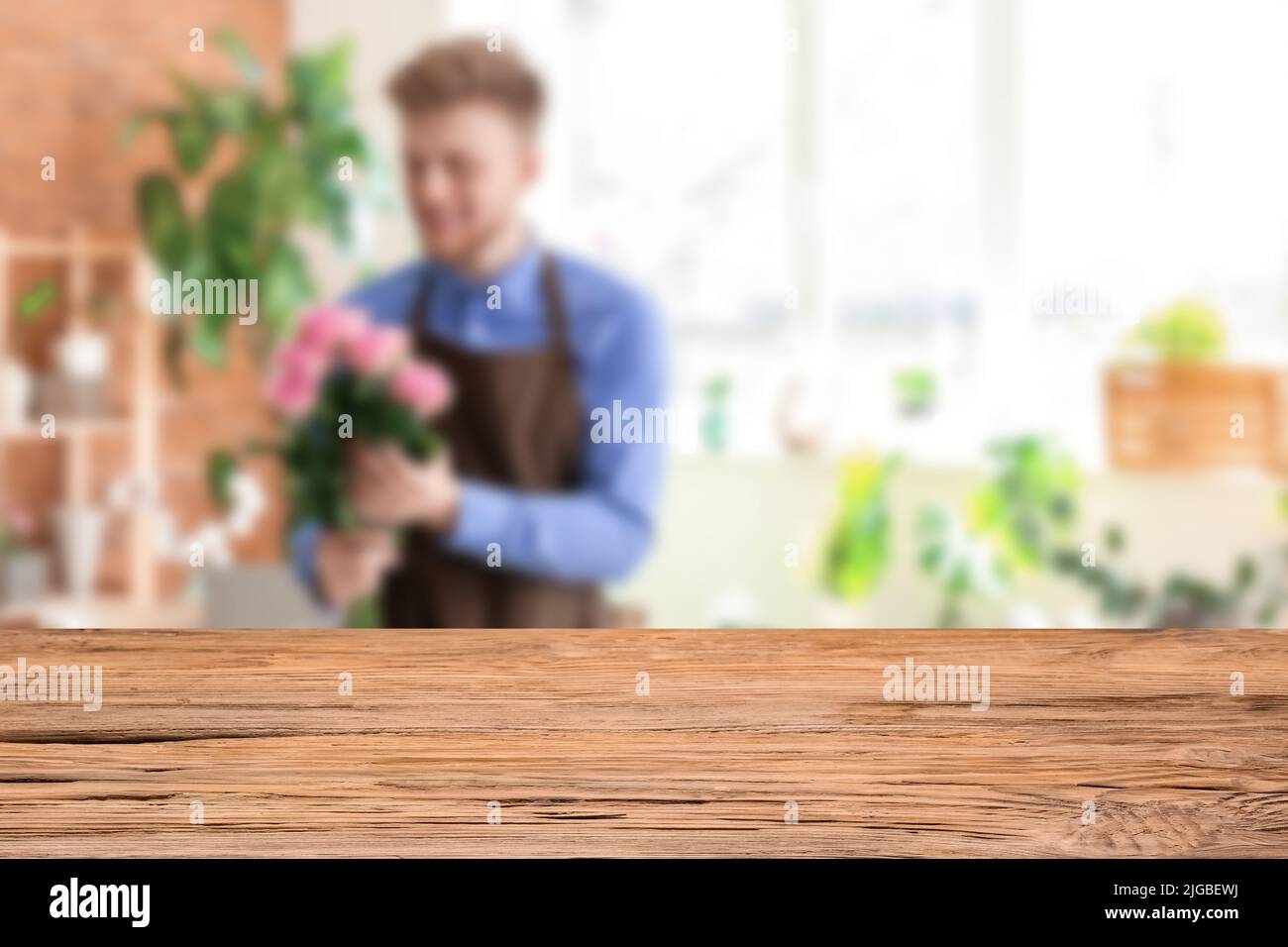 Empty wooden table in flower shop Stock Photo - Alamy
