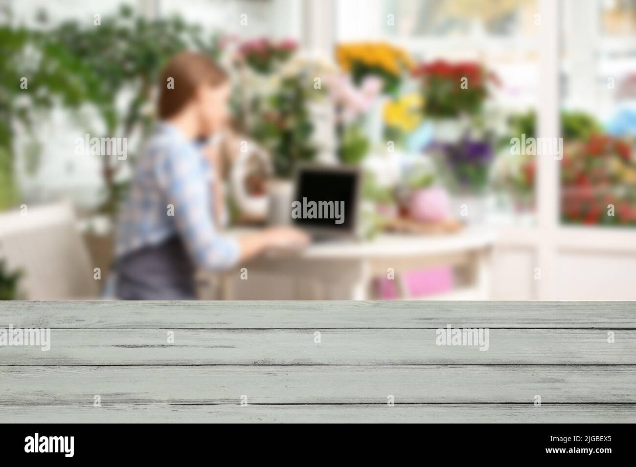 Empty wooden table in flower shop Stock Photo - Alamy