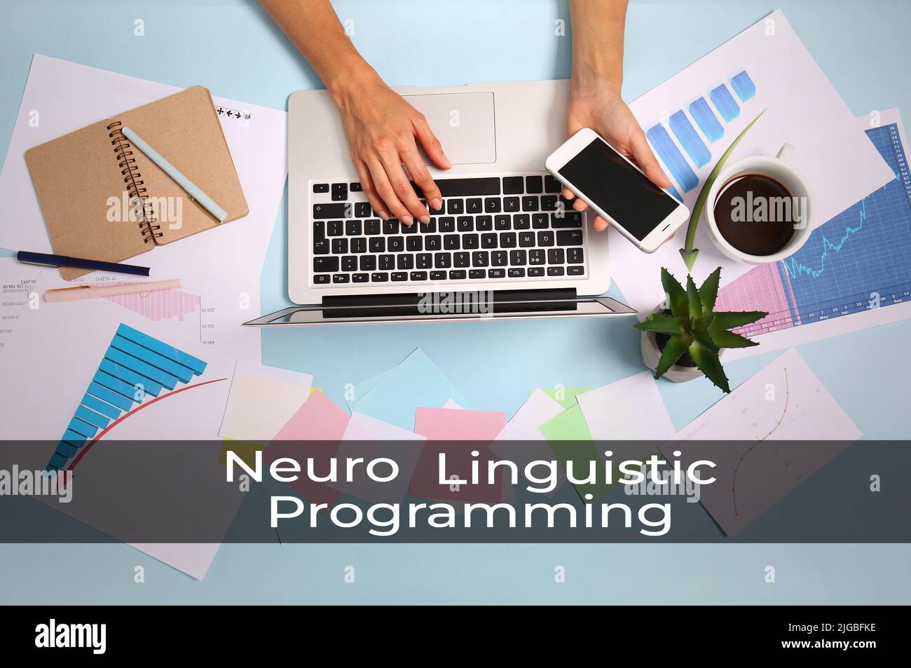 Woman with phone using laptop on light blue background, top view. Neuro ...