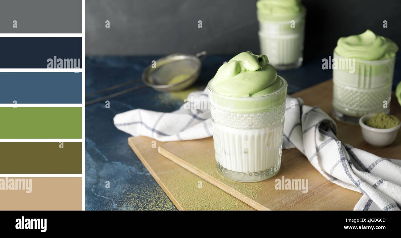 Glass of tasty dalgona matcha latte on table. Different color patterns ...