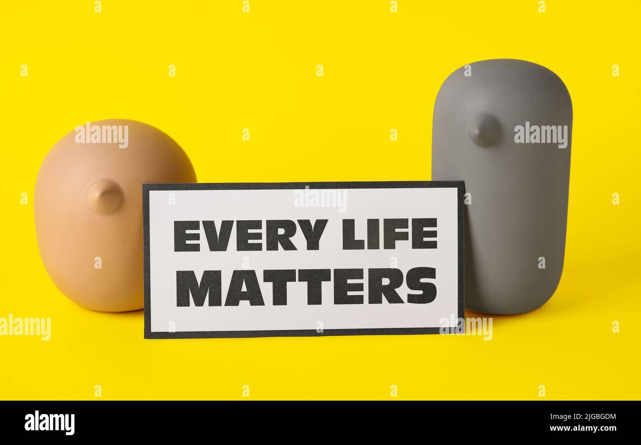 Figurines of birds and paper sheet with text EVERY LIFE MATTERS on ...