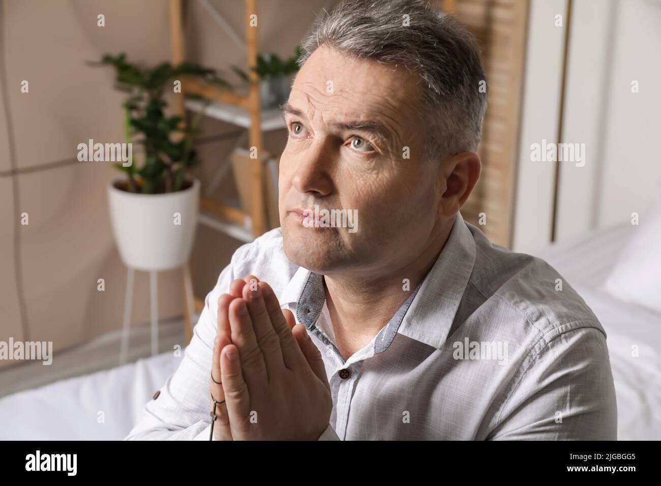 Man in bed praying hi-res stock photography and images - Alamy