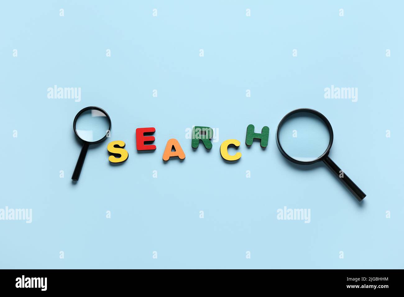 Word SEARCH and magnifying glasses on light blue background Stock Photo ...