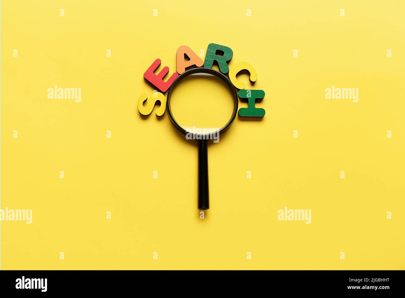 Magnifying glass and word SEARCH on yellow background Stock Photo - Alamy