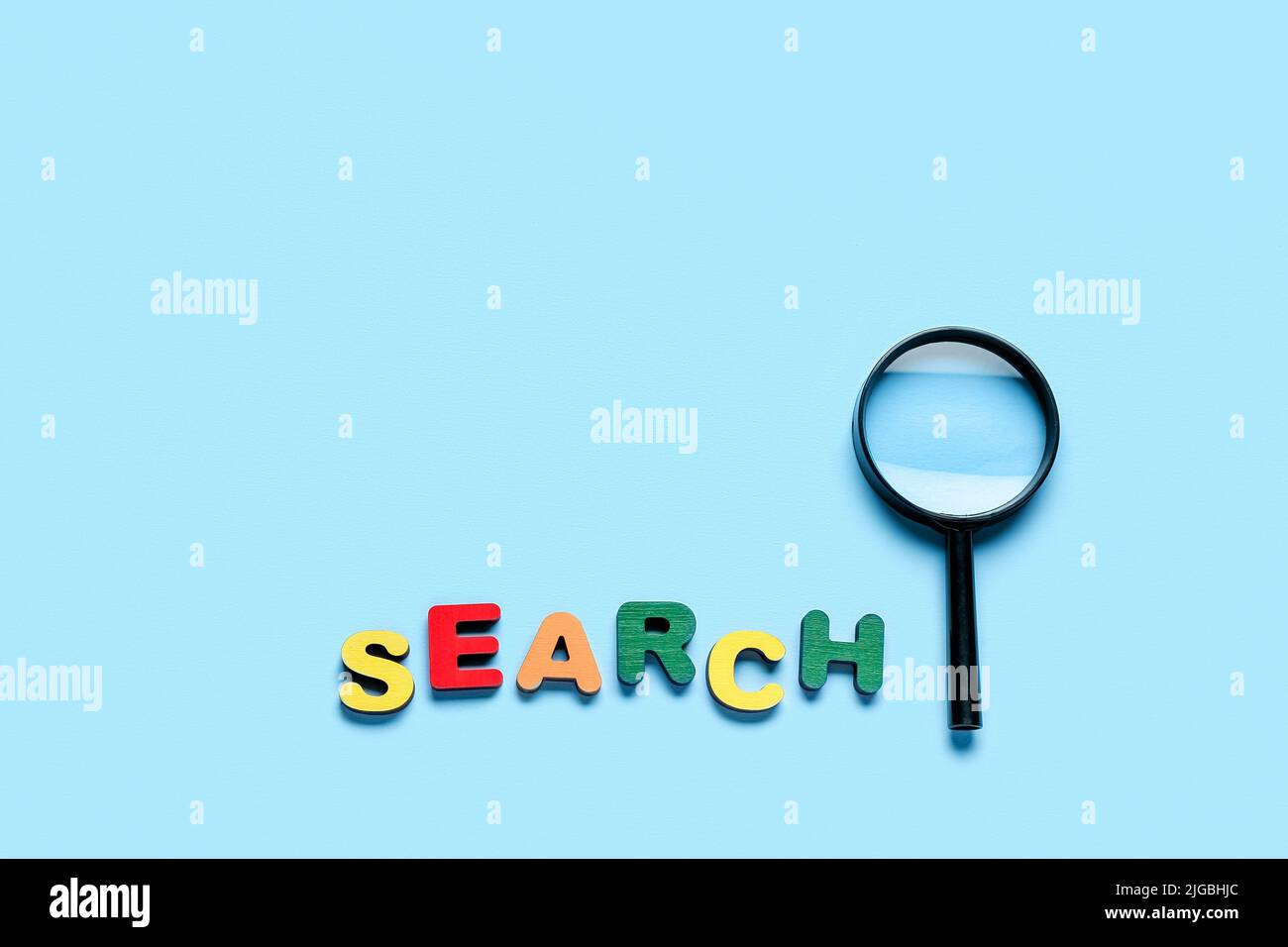 Word SEARCH and magnifying glass on light blue background Stock Photo ...