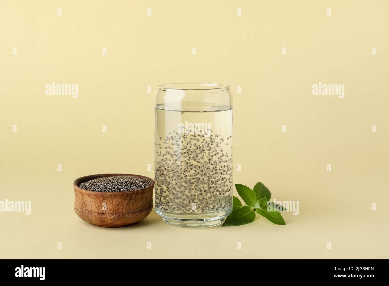 Glass of water and bowl with chia seeds on color background Stock Photo ...