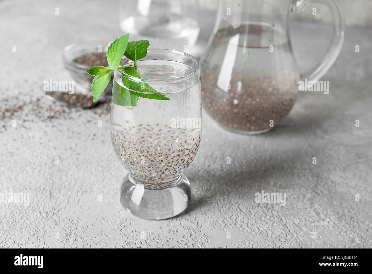 Glass of water with chia seeds and fresh mint on light background Stock ...