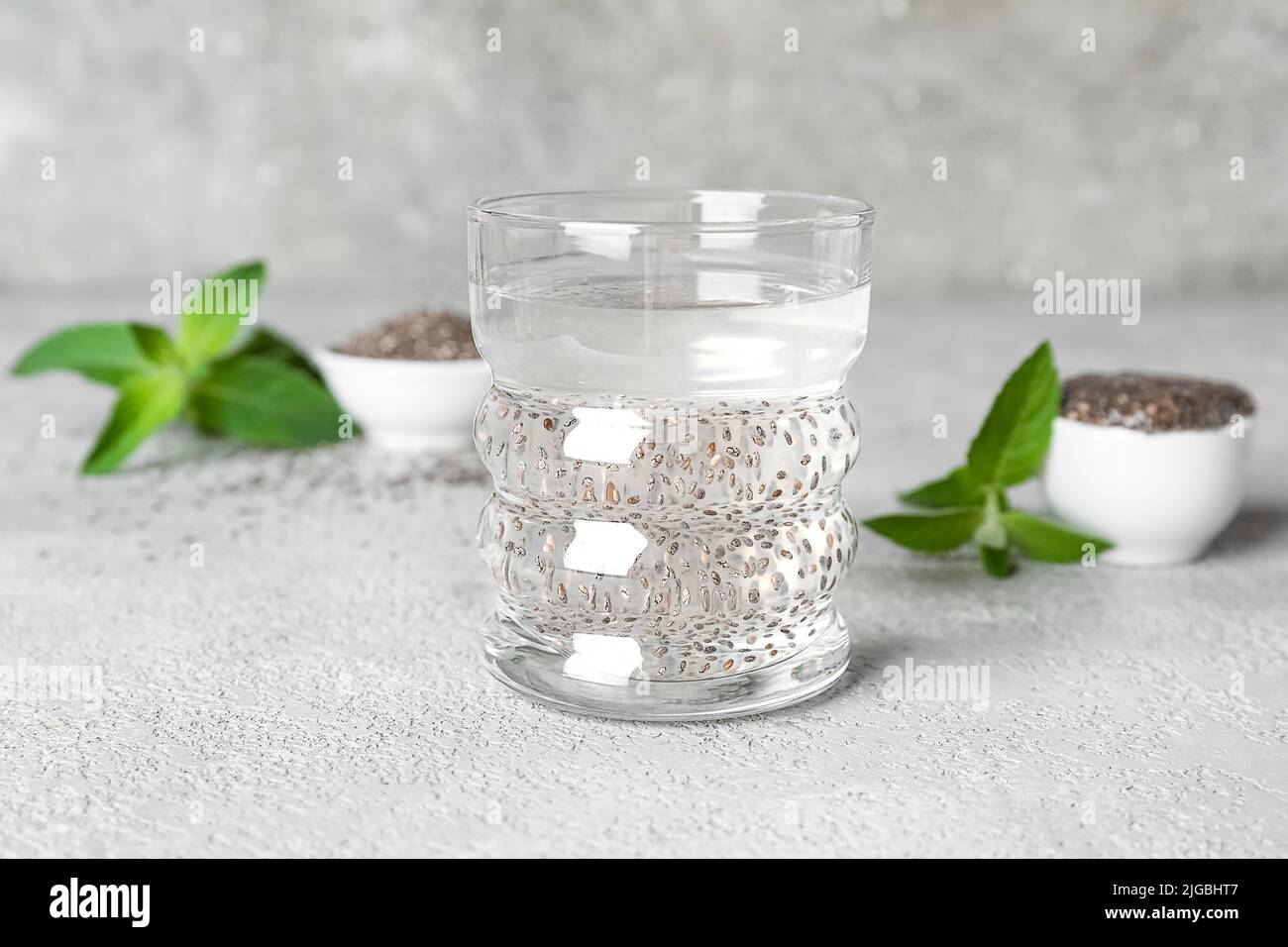 Glass of water with chia seeds on table Stock Photo - Alamy