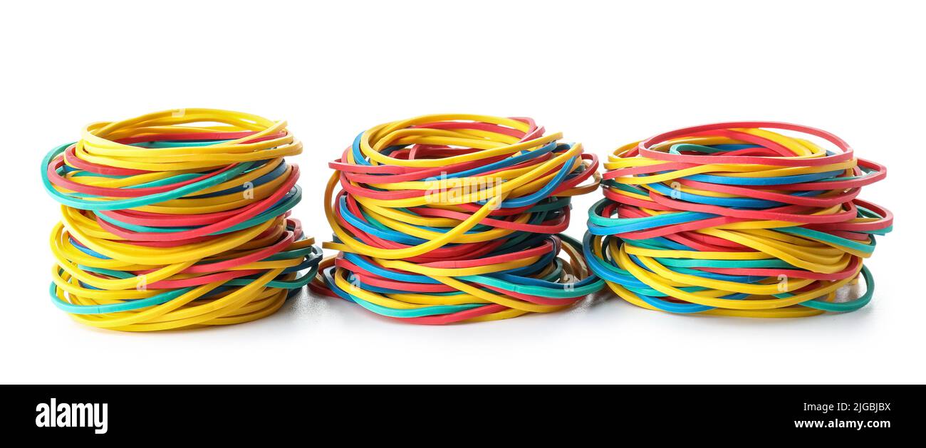 Three stacks of colorful rubber bands isolated on white background ...