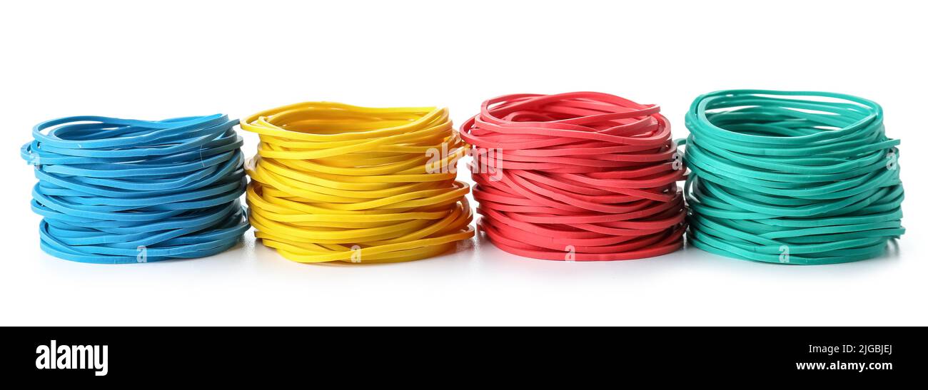 Many stacks of different rubber bands on white background Stock Photo ...