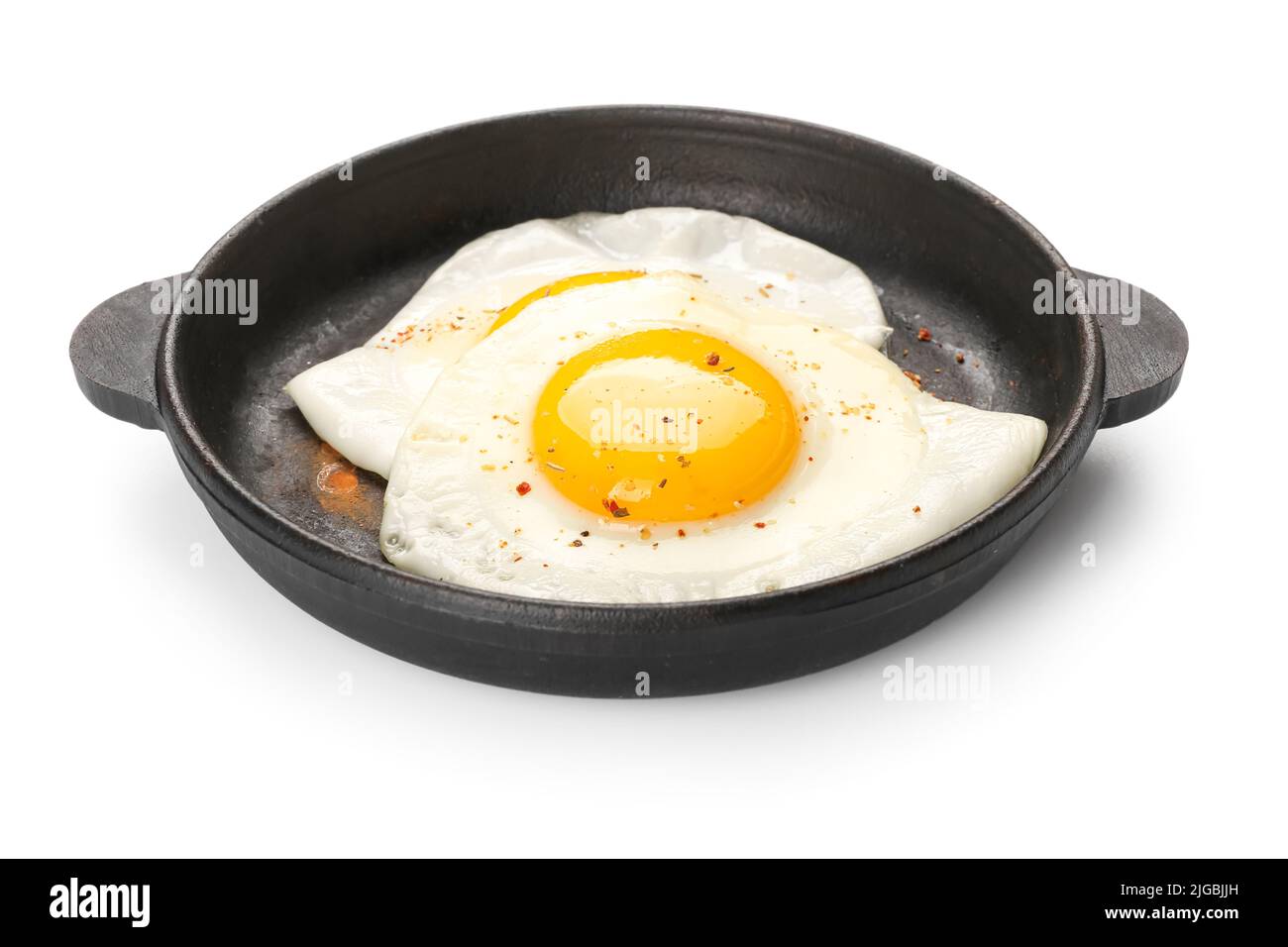 Frying pan with tasty eggs isolated on white background Stock Photo - Alamy