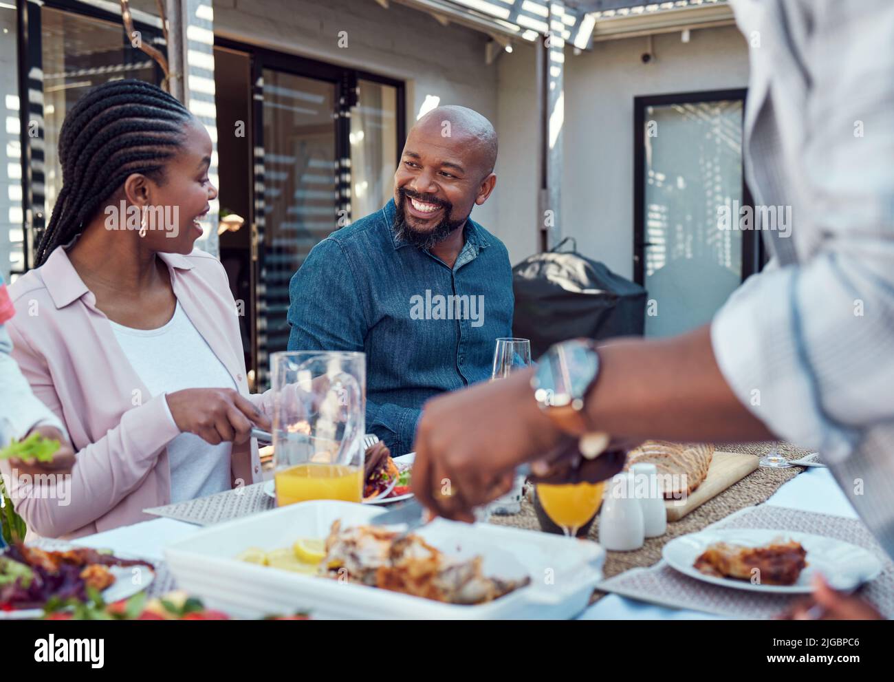 Family lunch. a happy family having lunch together outside in the ...
