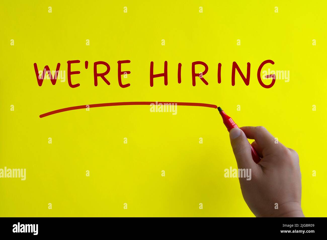 Hand writing we are hiring on yellow cover background. Hiring concept ... Hand writing we are hiring on yellow cover background. Hiring concept ...