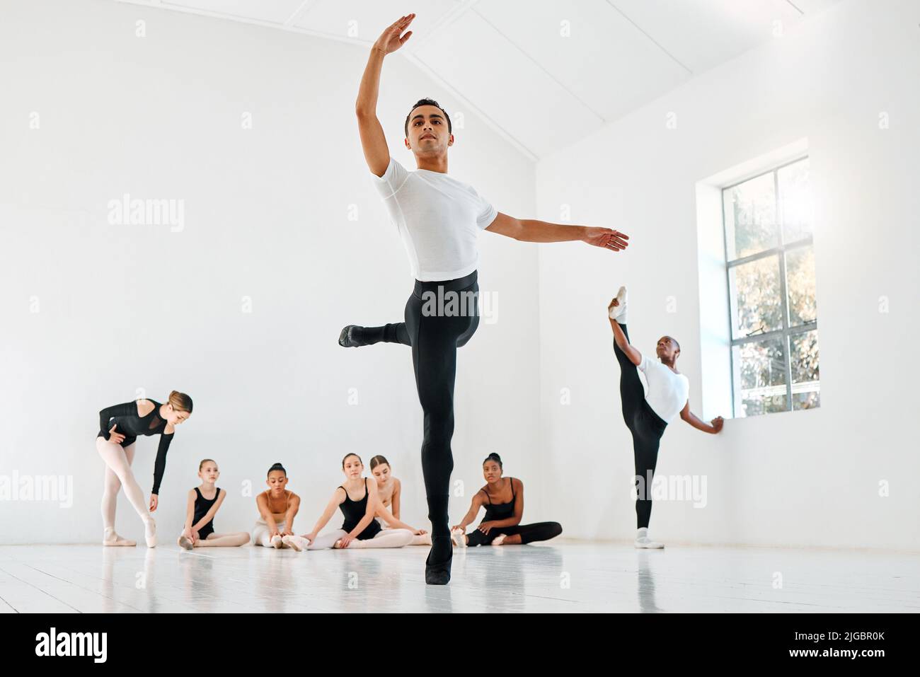 Expressing himself through dance. Full length shot of a diverse group ...