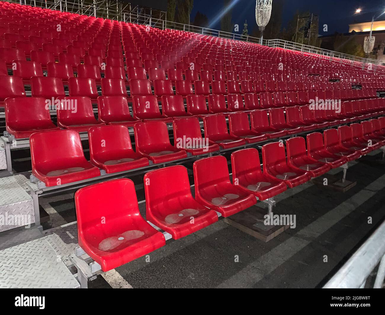 Bright red stadium seats at night Stock Photo - Alamy