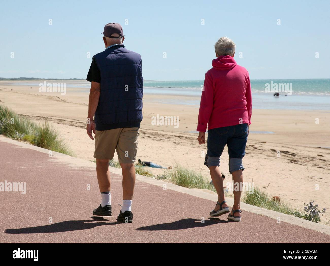 Keeping in step on the promenade, Pirou Plage, Normandy, France, Europe ...