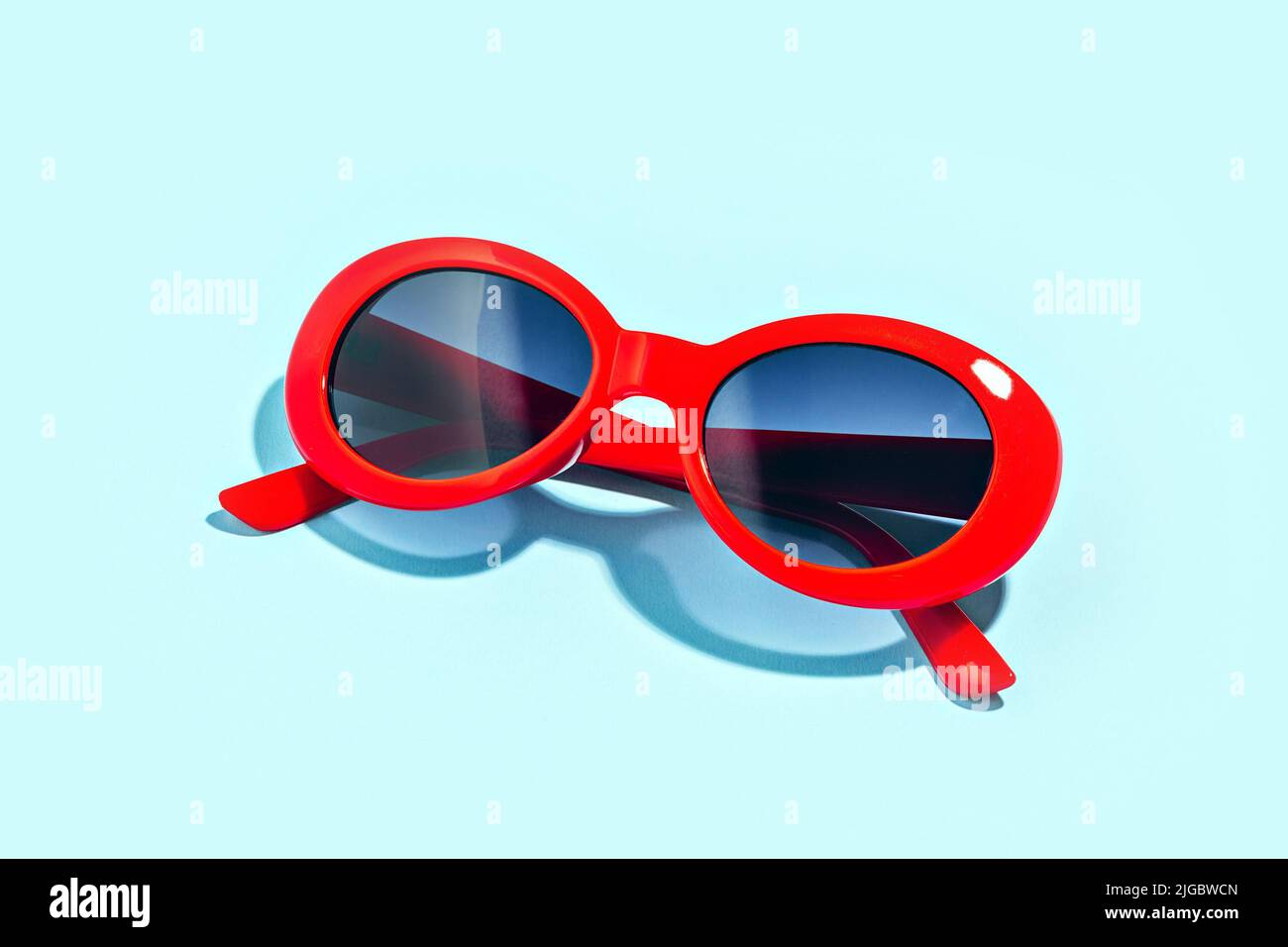 Red sunglasses on mint color paper background Stock Photo - Alamy
