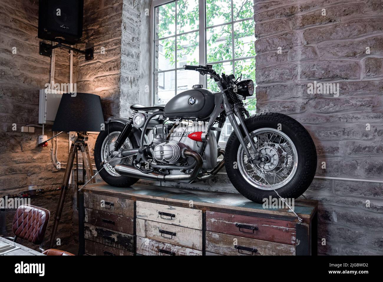 Motorcycle on weathered table by lamp against window in One sixty ...