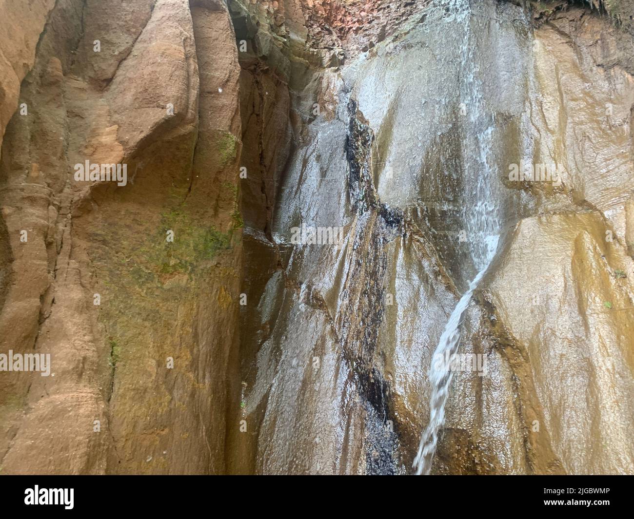 Small Waterfall flowing among red rocks Stock Photo - Alamy